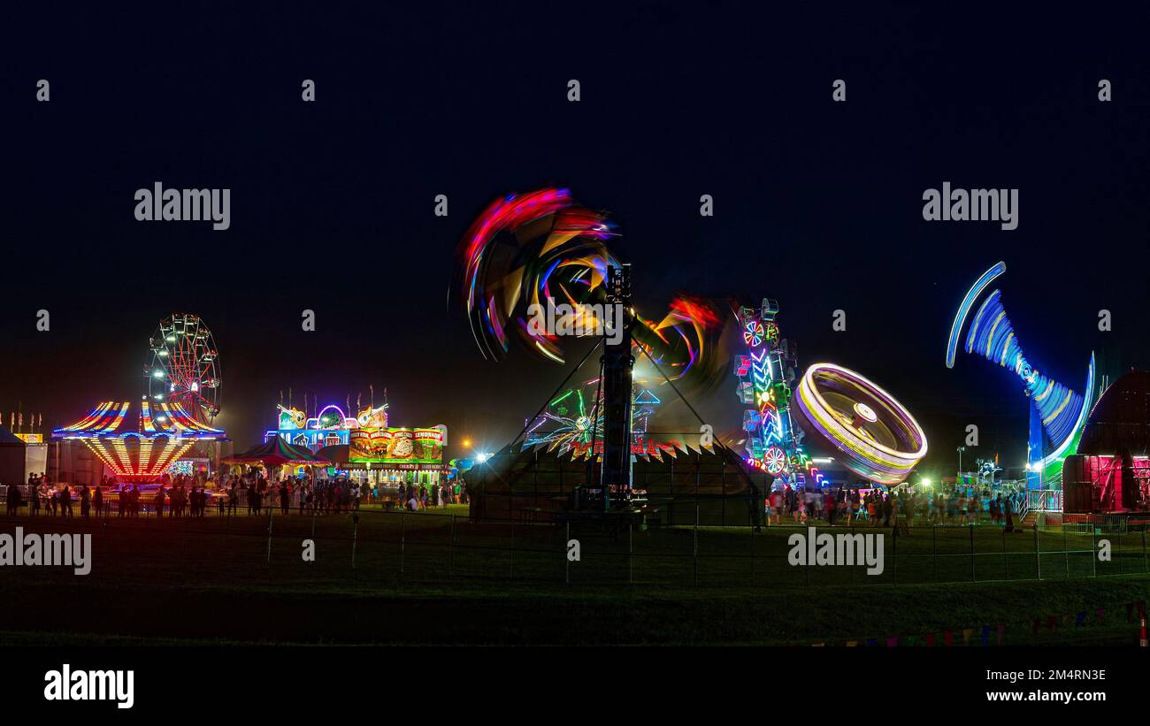 A long exposure shot of the Carnival Fair Rides at night Stock Photo ...