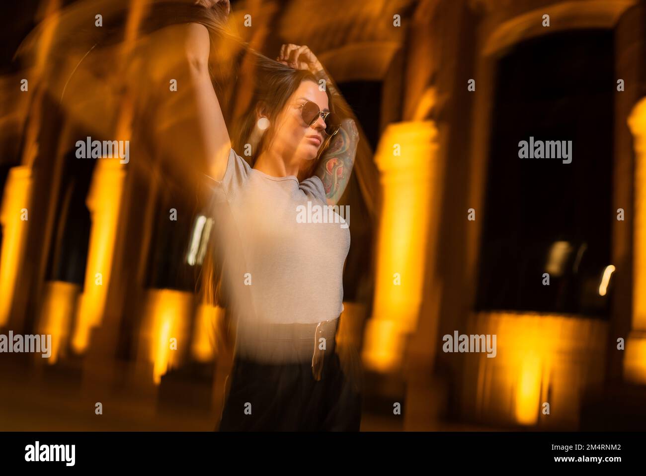 Motion blur portrait a dancing young fashionable woman wearing glasses ...