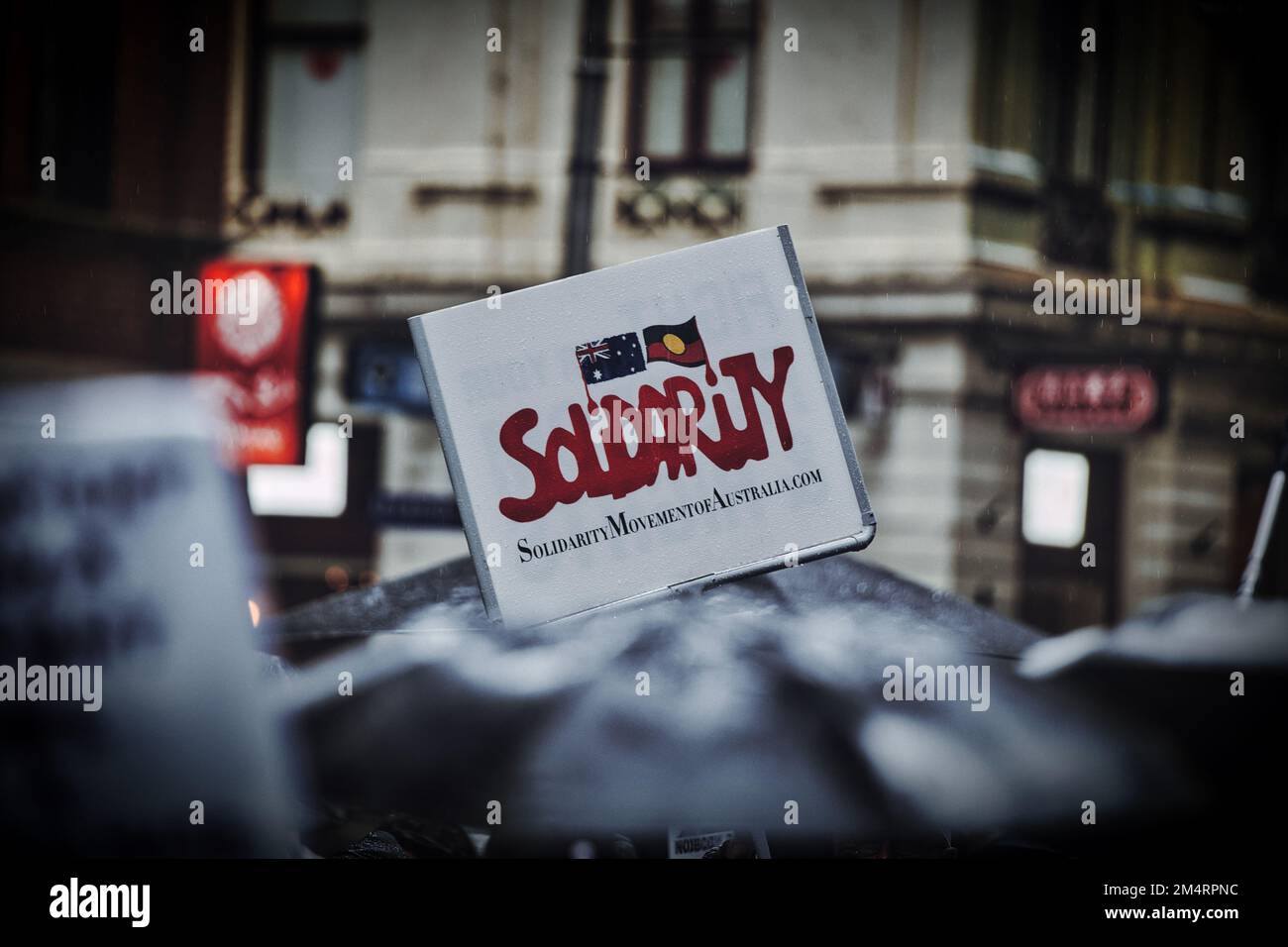 An aerial view of people carrying signs in a freedom protest in ...