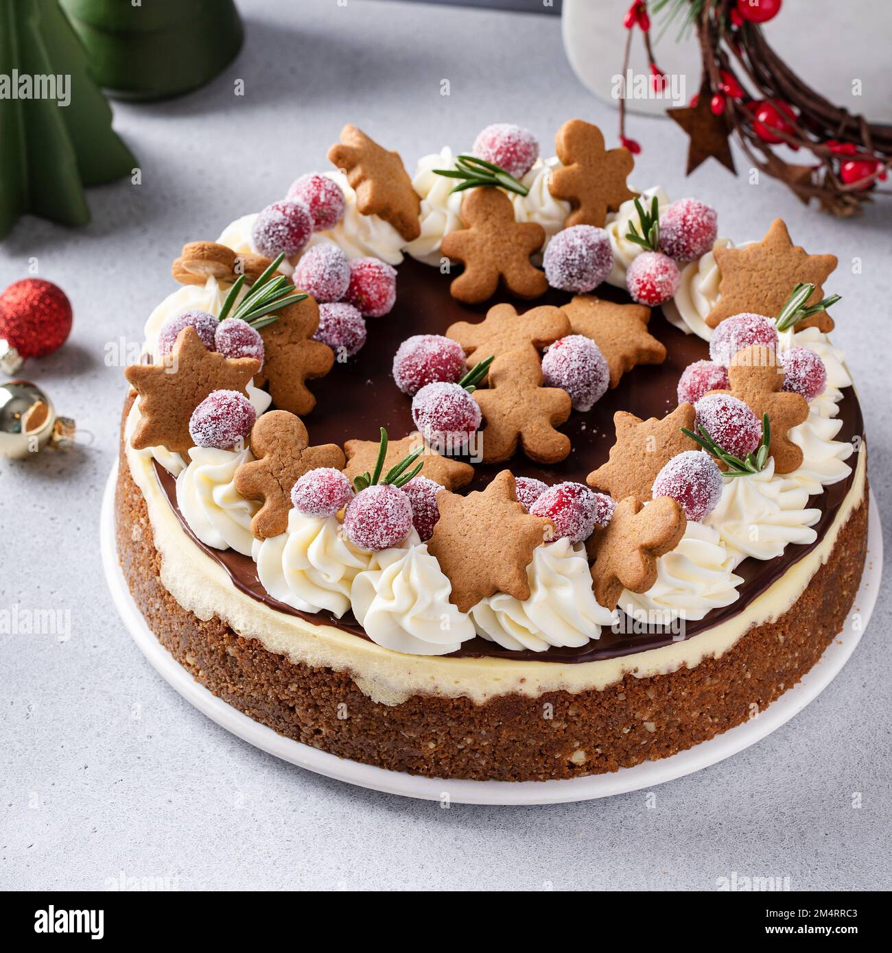 Christmas cake decorated with gingerbread cookies and sugared cranberry ...