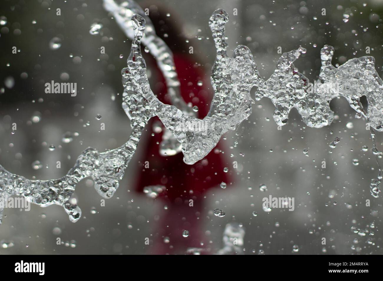 Water splashes large removed. Flight jet water. City fountain in detail ...