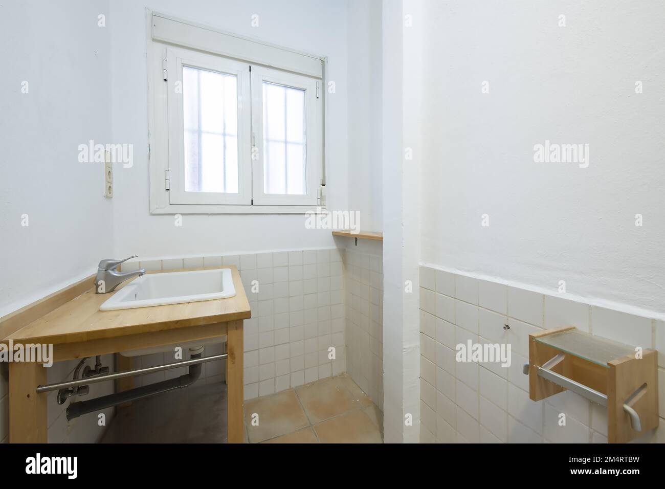 Toilet with white porcelain sink integrated into a wooden cabinet ...