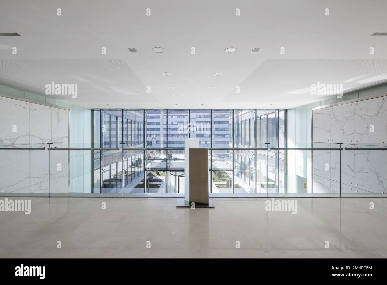 Atrium of an office building with green marble tiled walls, cream ...