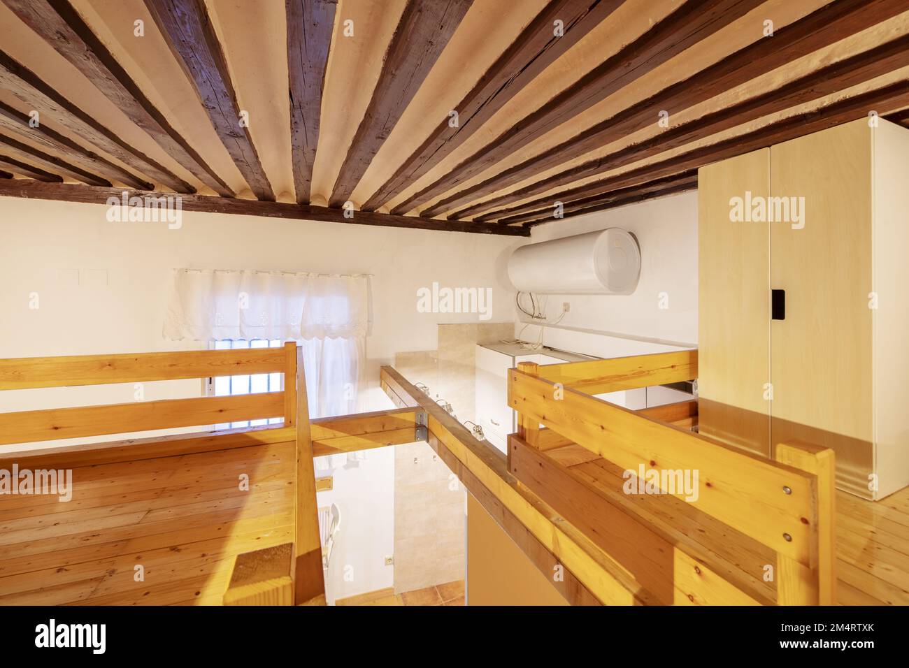 Pine wood structure in a mezzanine of a studio apartment with exposed ...