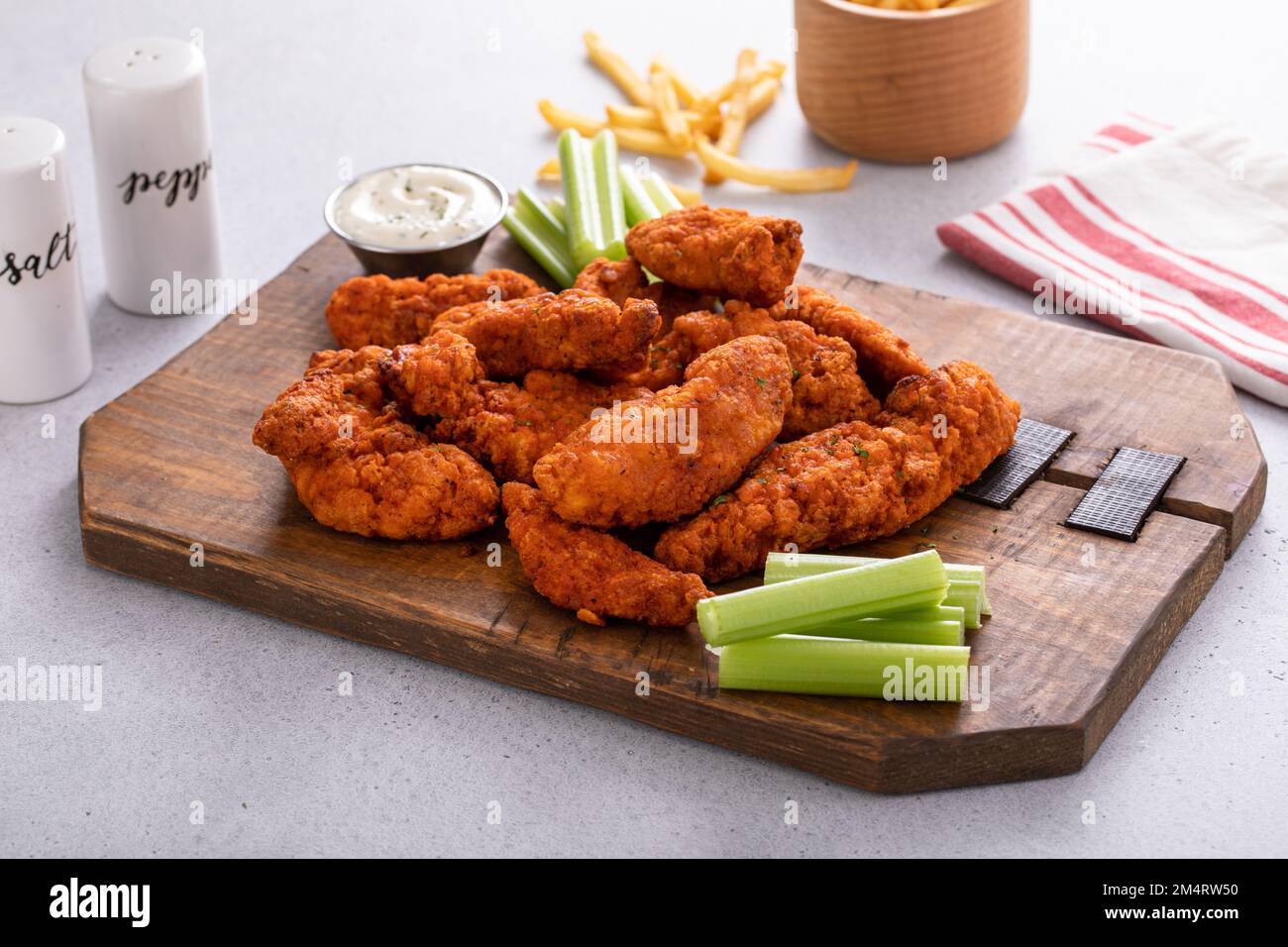 Buffalo chicken fingers served with ranch sauce and celery Stock Photo ...
