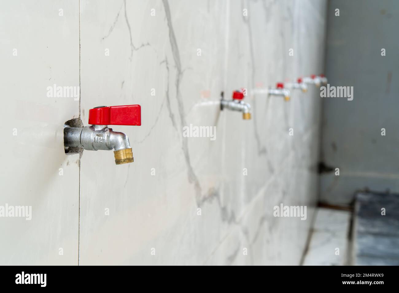 Row of water faucets in public facilities Stock Photo - Alamy