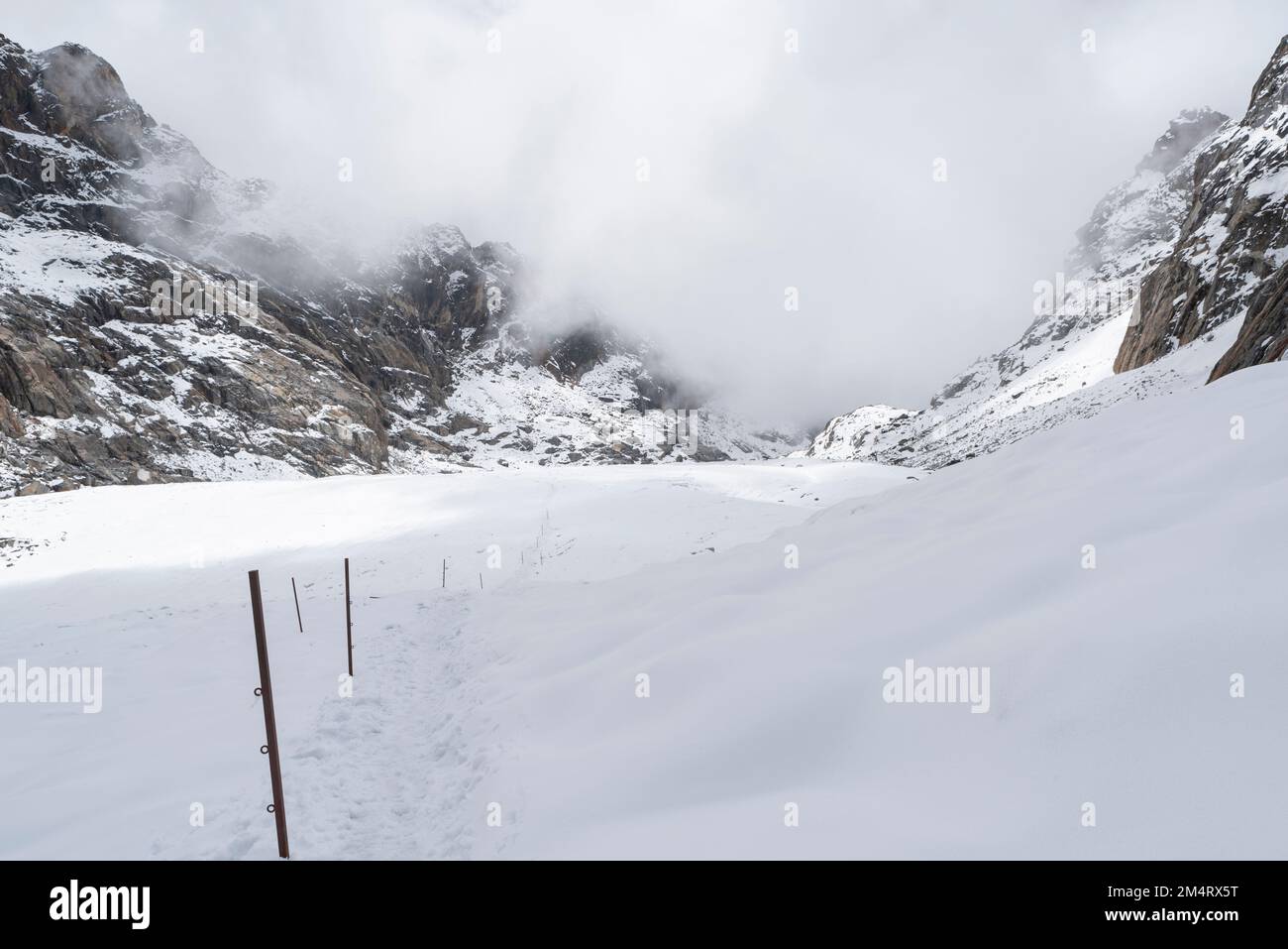 A beautiful view of a snow-capped trek with iron spikes to follow the ...