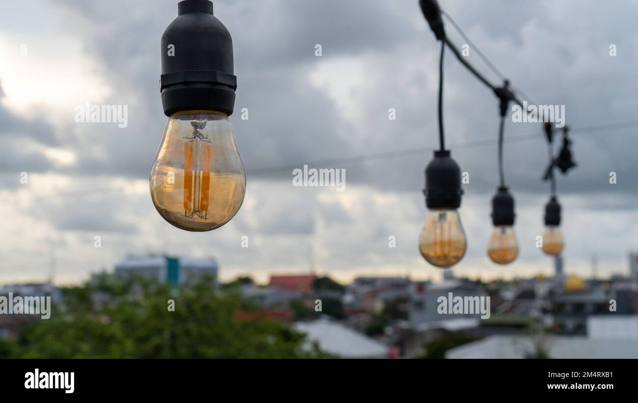Lamps hang in the afternoon. The lamps are on. A row of lamps in a cafe ...