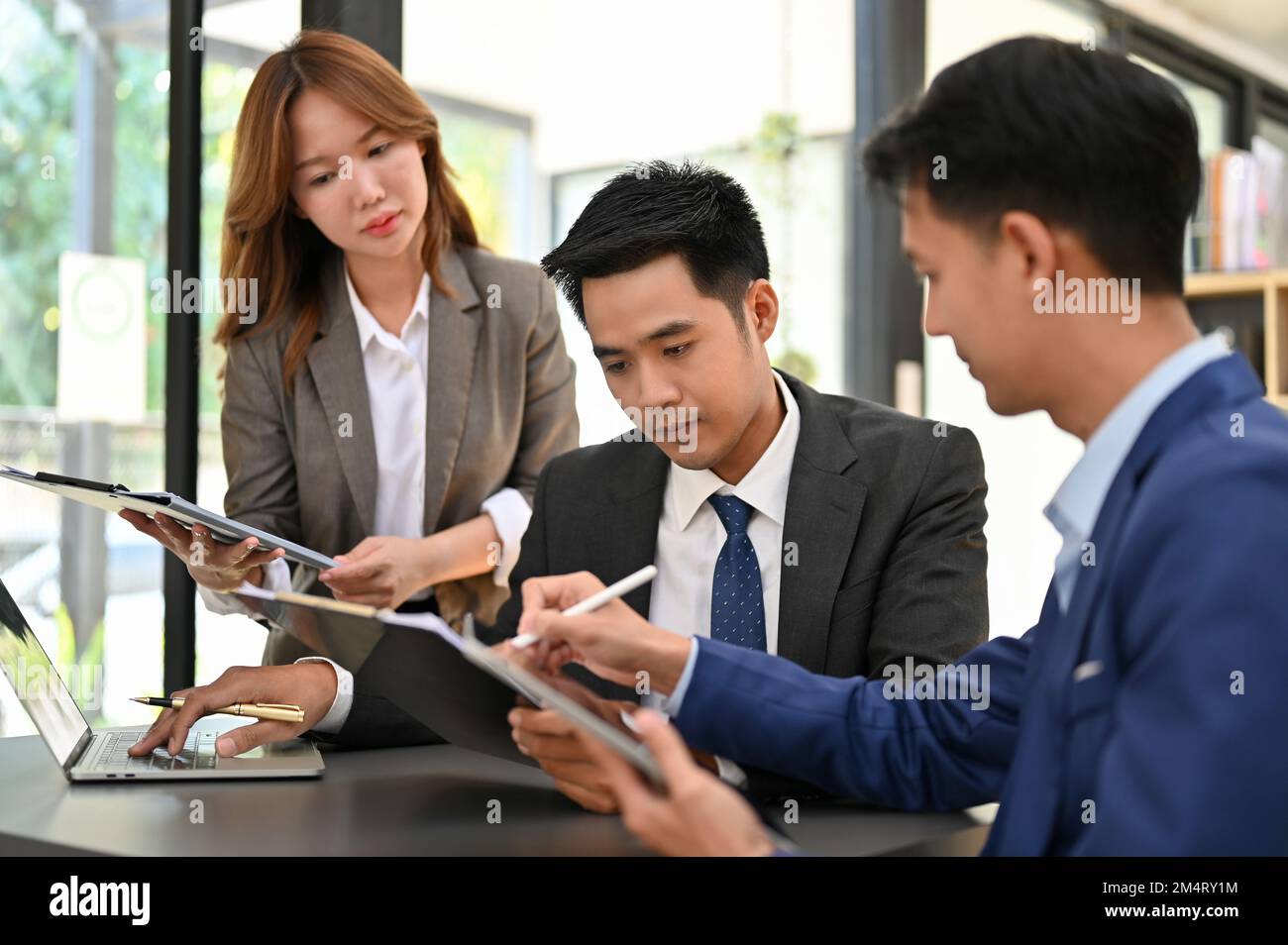 Professional and smart millennial Asian male boss working with his ...