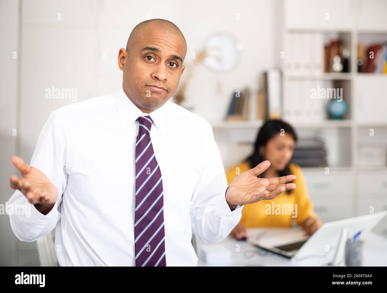 Puzzled and confused office employee making helpless gesture Stock ...
