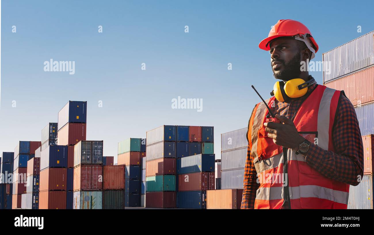 American African engineer or factory worker man using walkie talkie and ...