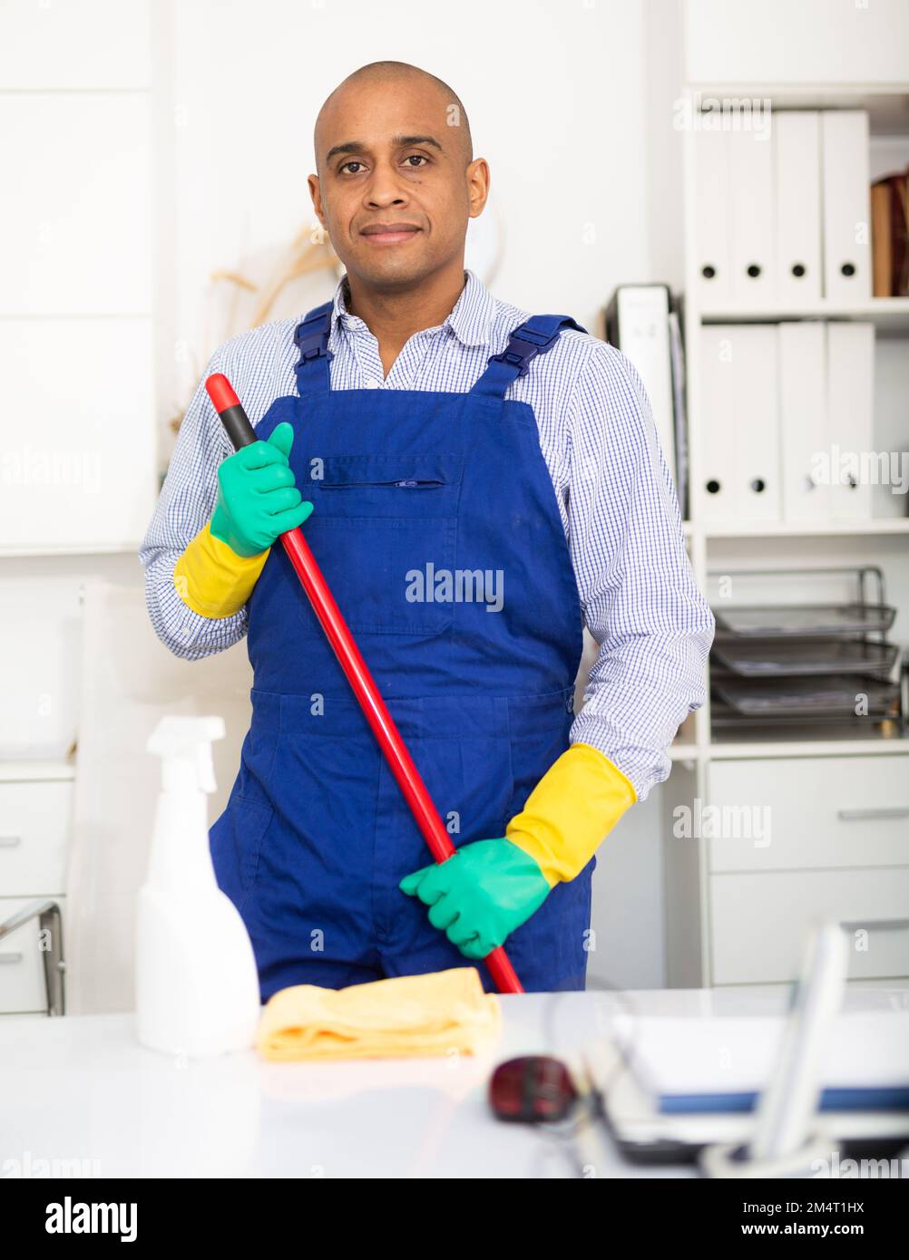 Cleaner in protective uniform at company office Stock Photo - Alamy