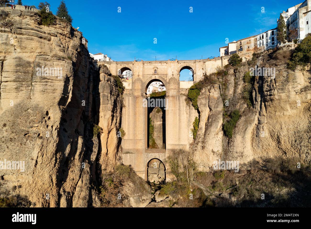 Rocky landscape of Ronda city with Puente Nuevo Bridge and buildings ...
