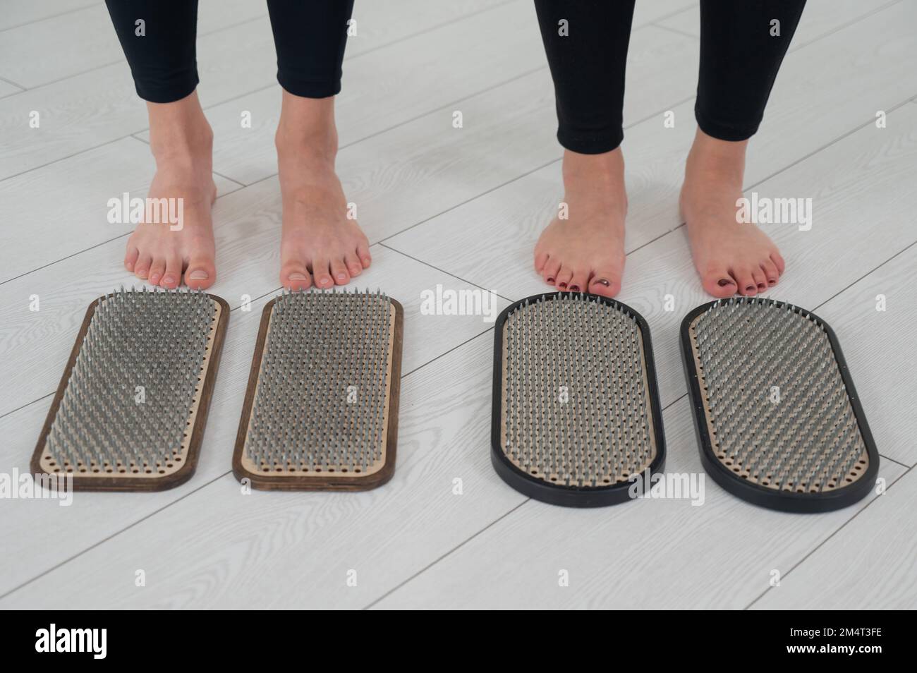 Close-up on the feet of two women in front of the sadhu's nails. Top ...