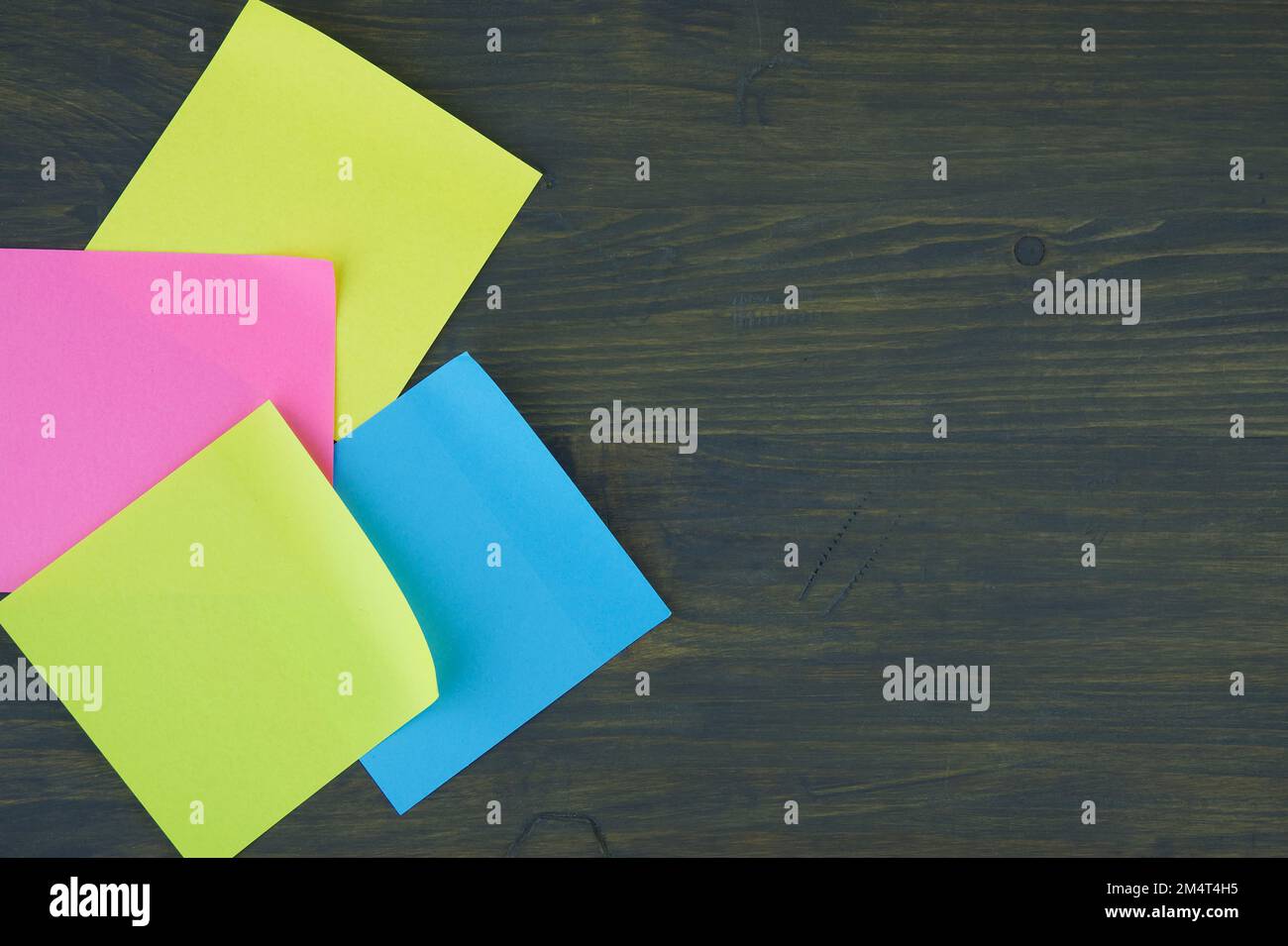 Empty color office paper for notice with curled corners on rustic board ...