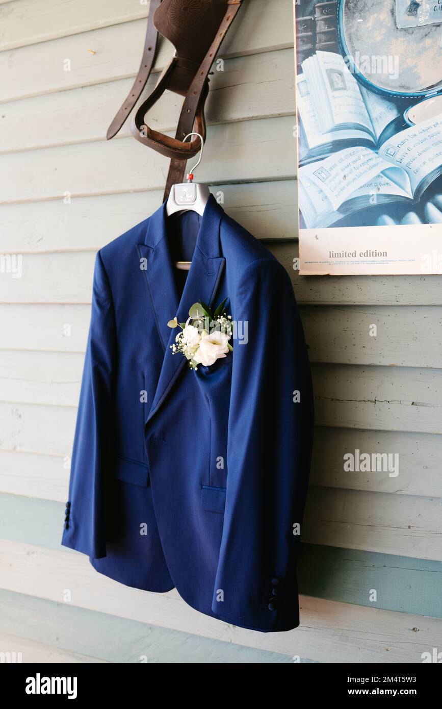 A vertical footage of a man's blue suit with flowers in the pocket ...
