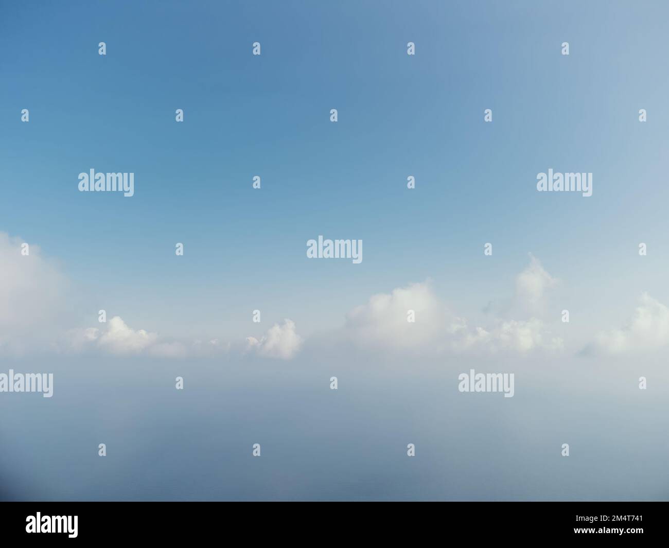 Blue sky with white clouds over calm summer panorama of the sea. Drone ...