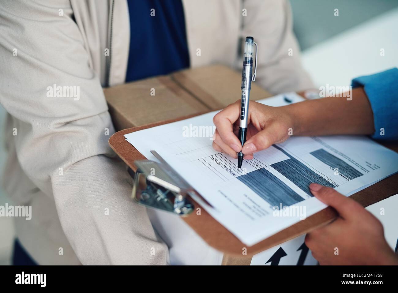 Signing for a parcel hi-res stock photography and images - Alamy