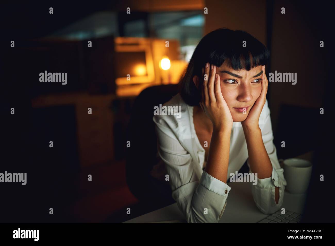 Quickly losing focus. a young businesswoman feeling tired during a late ...