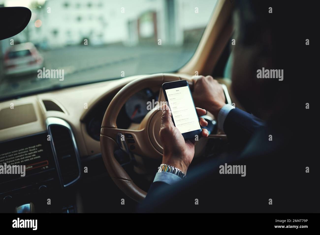 Gps knows the way. a businessman using his phones gps while driving a ...