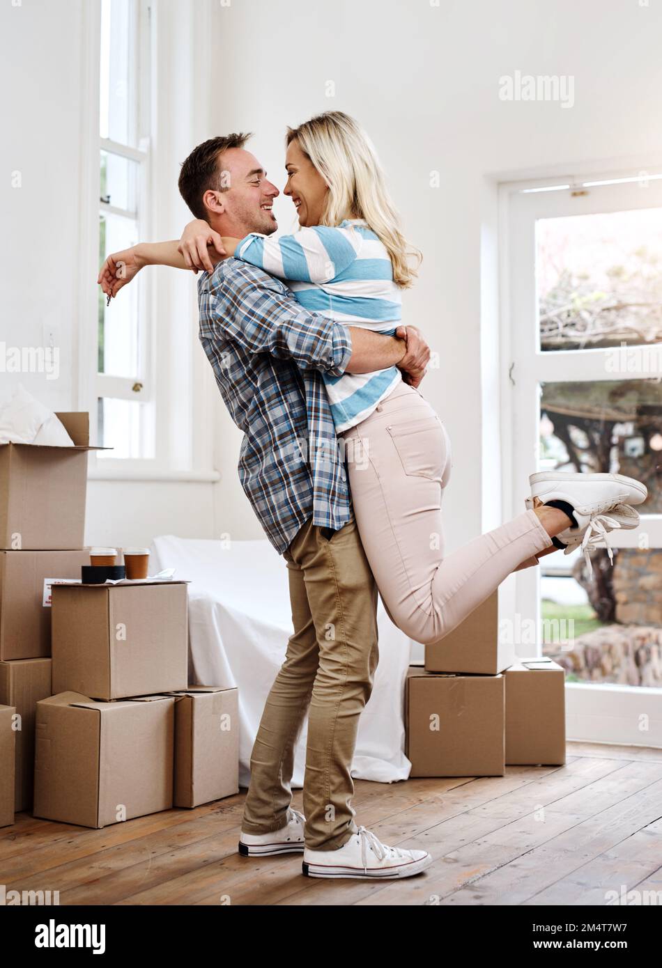 Our dream has come true. a young couple celebrating their move into a ...