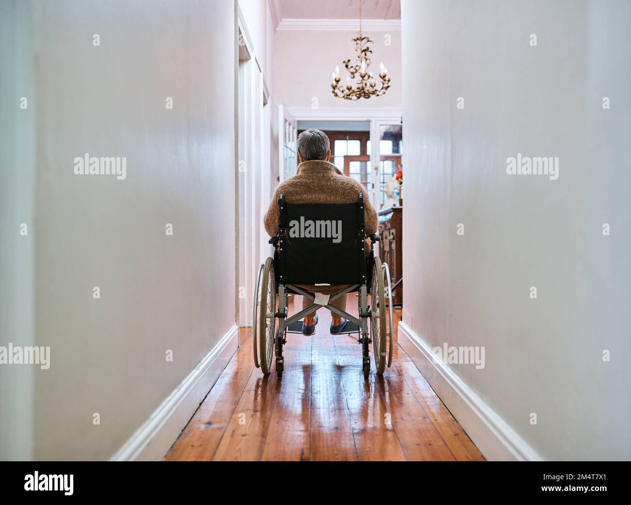 Recovering at home. Rearview shot of a senior woman sitting in her ...
