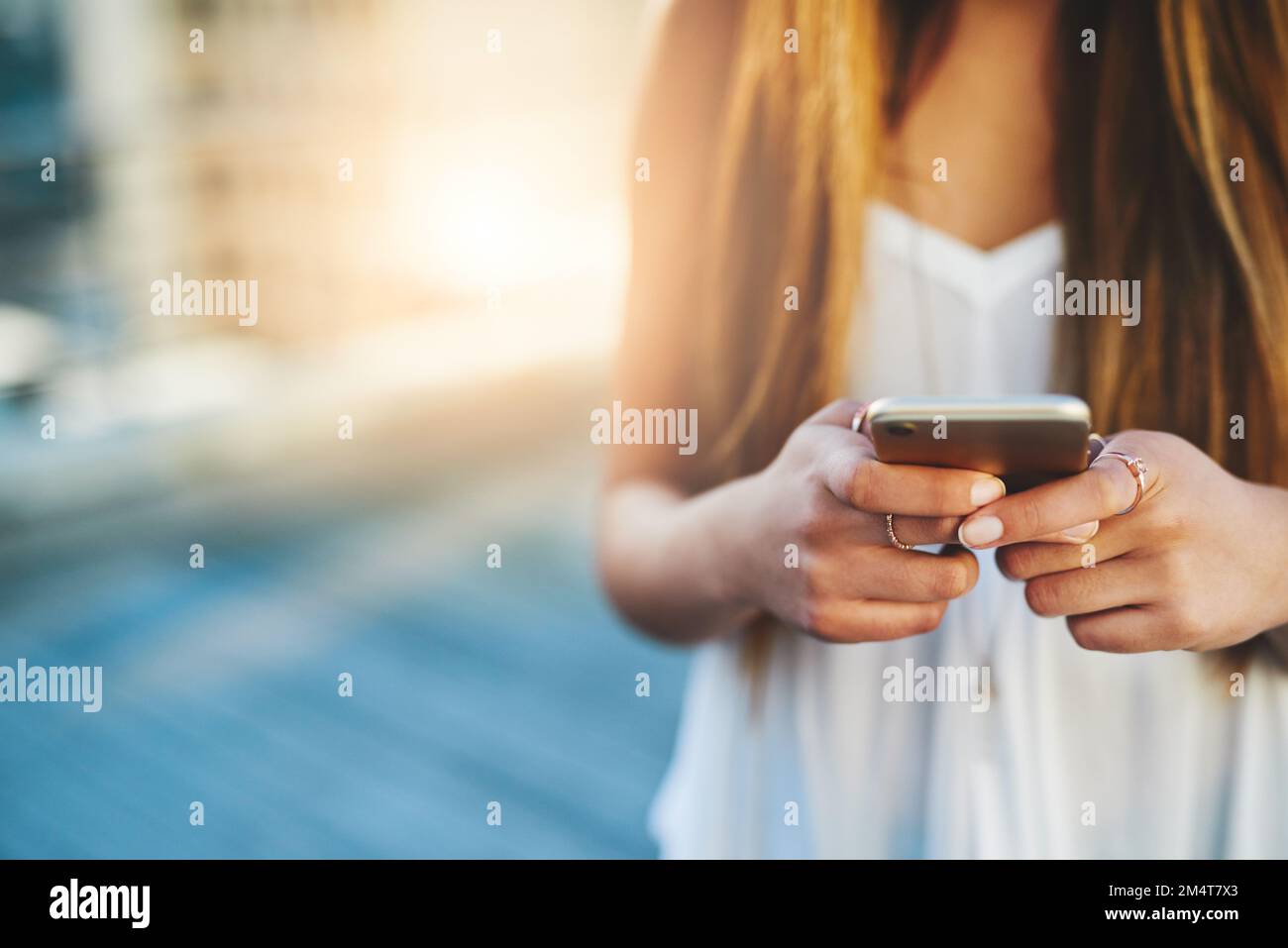 Checking her social media feeds. an unrecognizable young woman sending ...