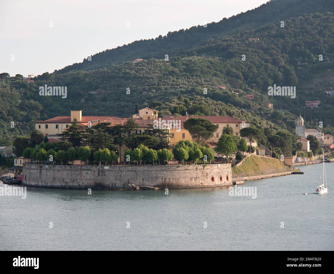 A drone shot over the Mediterranean and trees, buildings with mountain ...