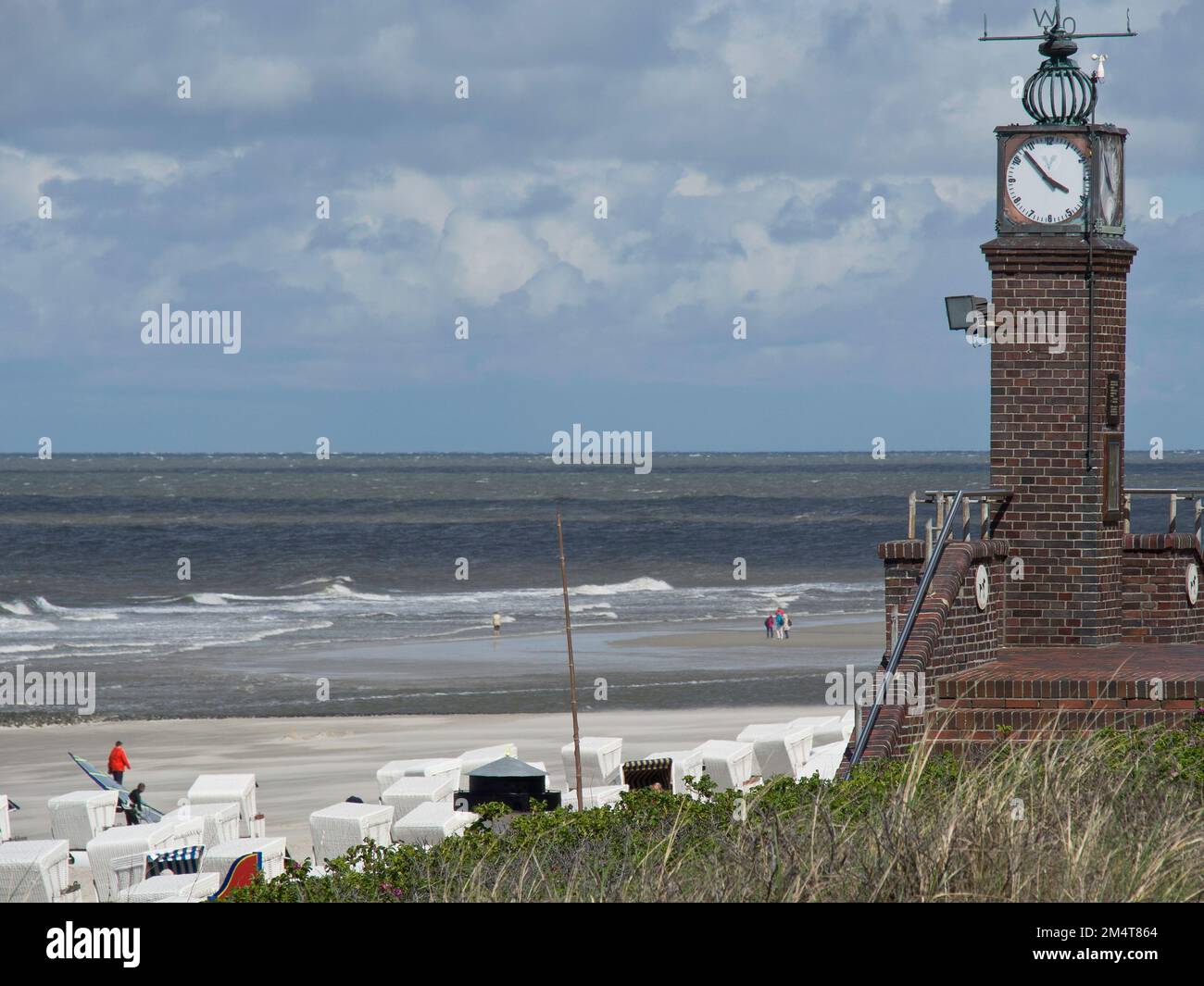 A clock tower on the beach of Wangerooge island, Germany Stock Photo ...