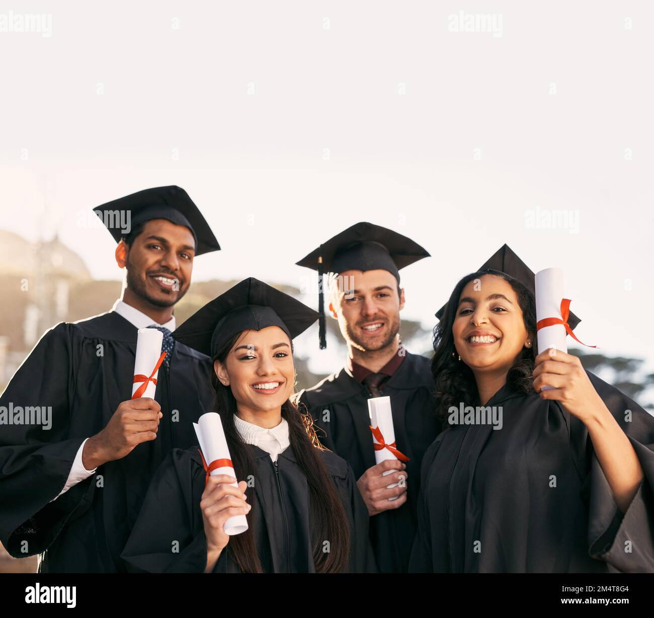 Its our big day. Portrait of a group of students celebrating with their ...
