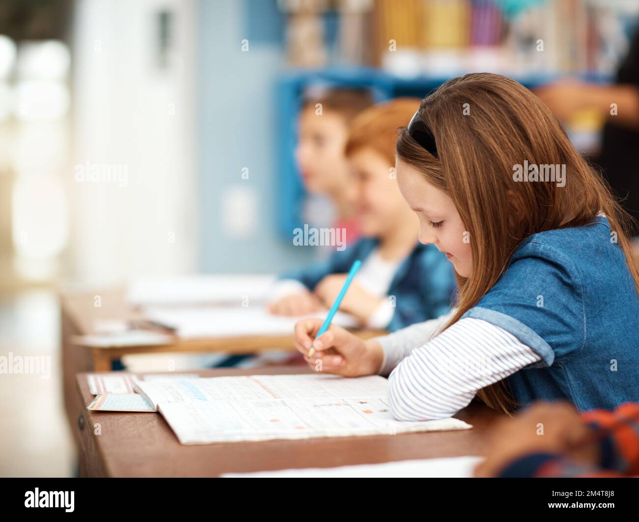 Busy bees at work. an elementary school girl working alongside her ...