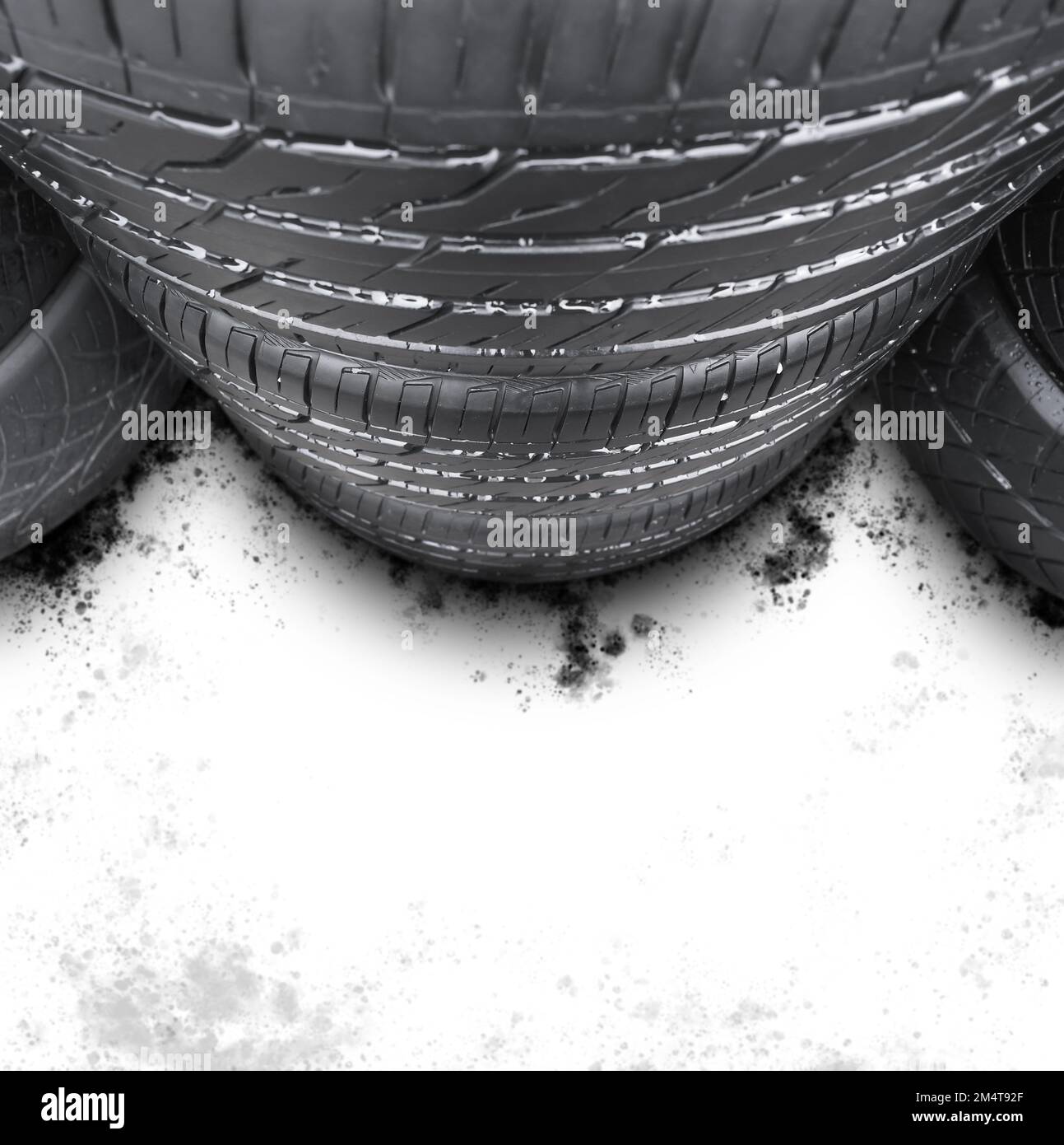 Pile of old tires laying on a dirty floor with copy space vertically ...