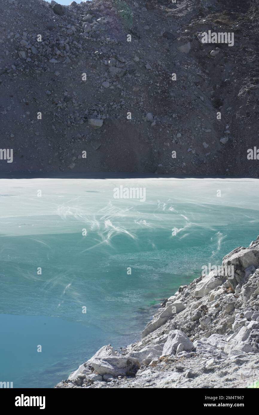 A vertical scenic view of the crystal clear water at the foot of the ...