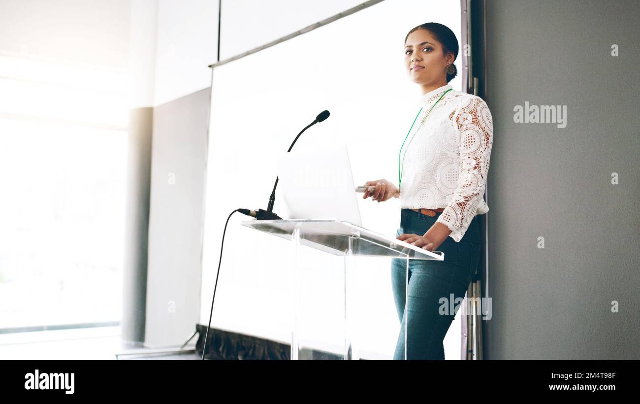 Preparing her speech. an attractive young businesswoman giving a speech ...