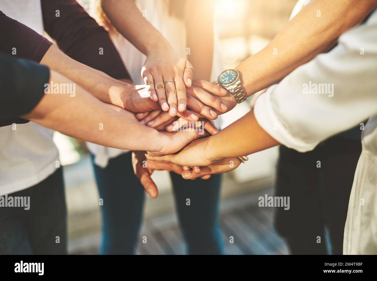 Together we can do more. an unrecognizable group of people putting ...