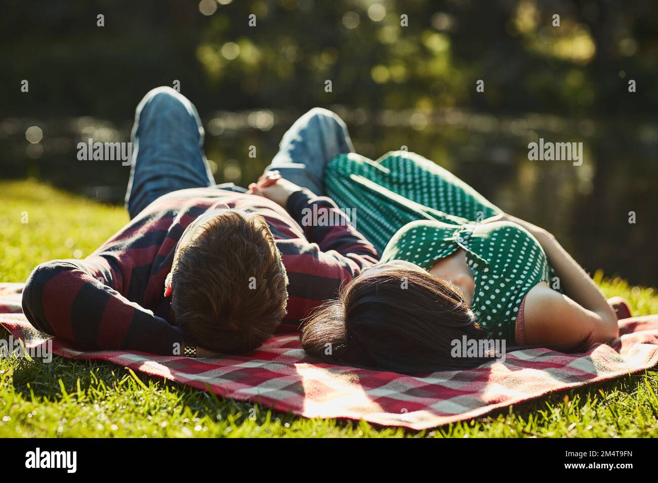 Those lazy afternoons with the one you love. a young couple lying ...