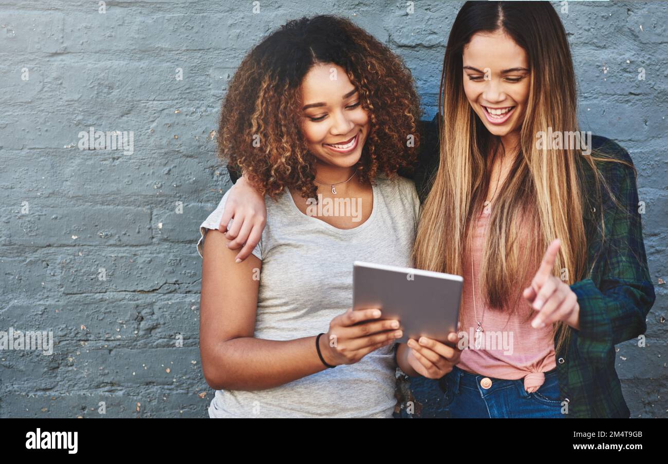 Connecting and getting closer. two young women standing outdoors and ...