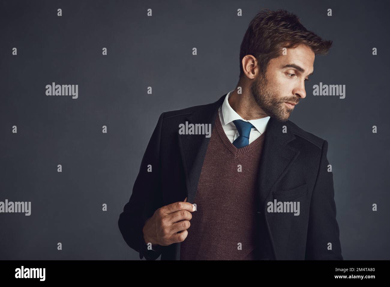 He knows what looks good on him. Studio shot of a stylishly dressed ...