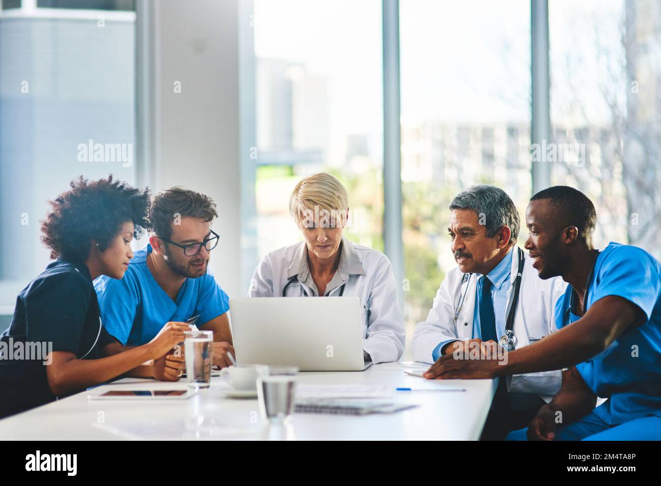 Quality medical care is a combined effort. a team of doctors using a ...