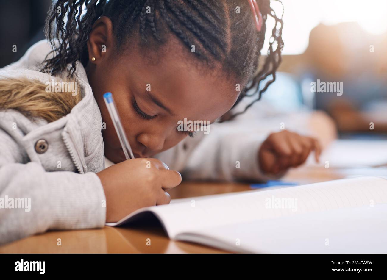 Focused on the task the teacher has given. an elementary school girl ...
