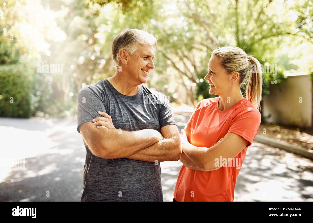 Are you challenging me to a run. a mature couple out jogging on a sunny ...