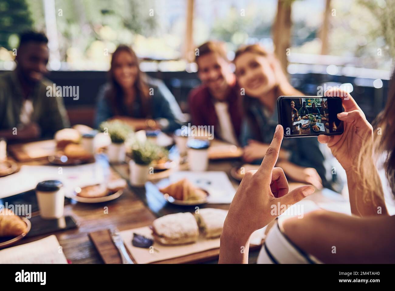 Everyone move in for a quick snap. a woman taking a picture of ...
