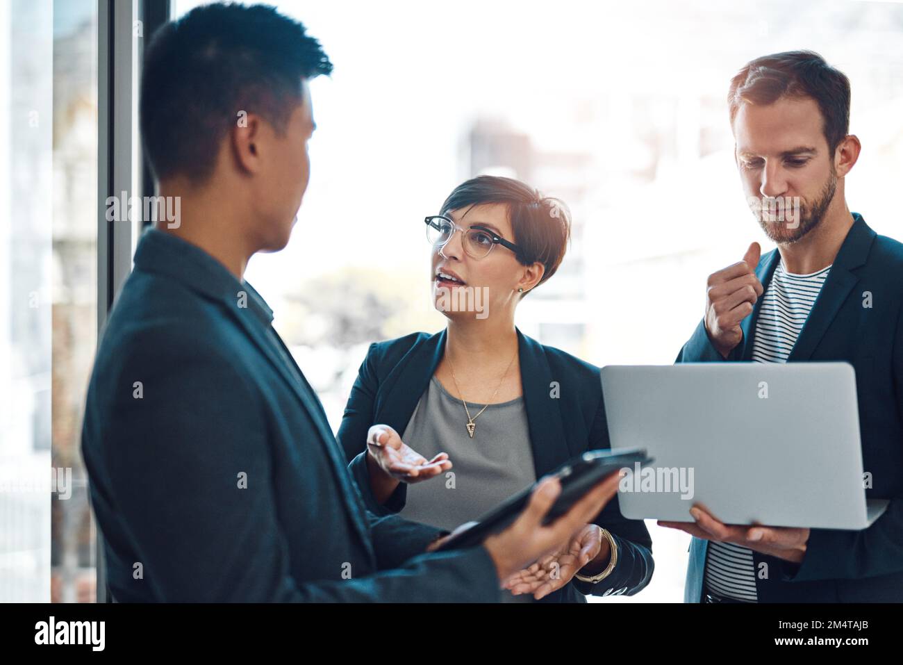 How will these devices help the company. colleagues using a laptop in ...