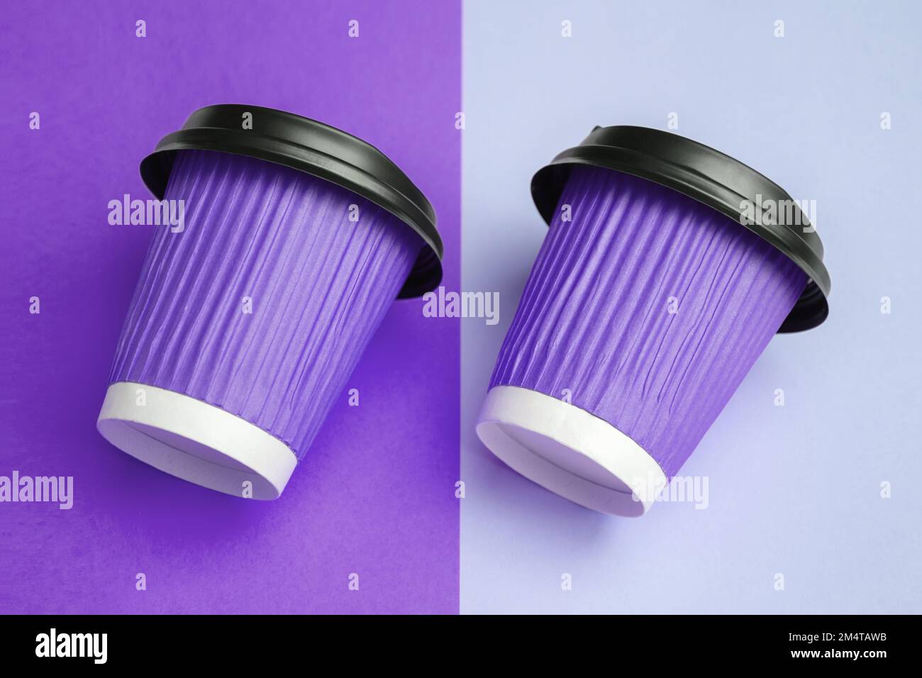 Close-up image of two purple paper cups for takeaway coffee or tea ...