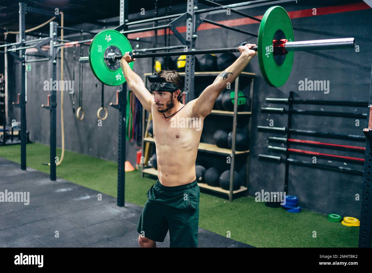 Profile photo of a strong caucasian man lifting weight in a gym Stock ...