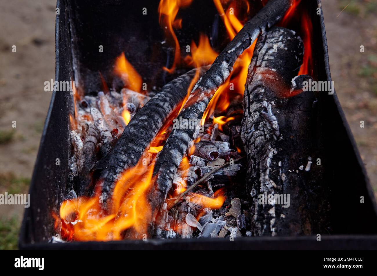 Burning red hot sparks fly from fire. Barbecue gril with glowing and ...