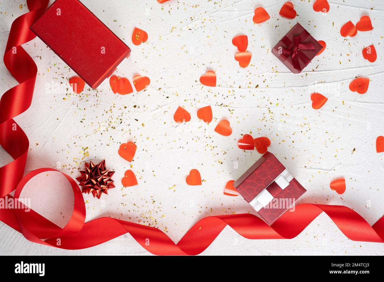 Valentines day composition with gift box, hearts and red ribbon on ...