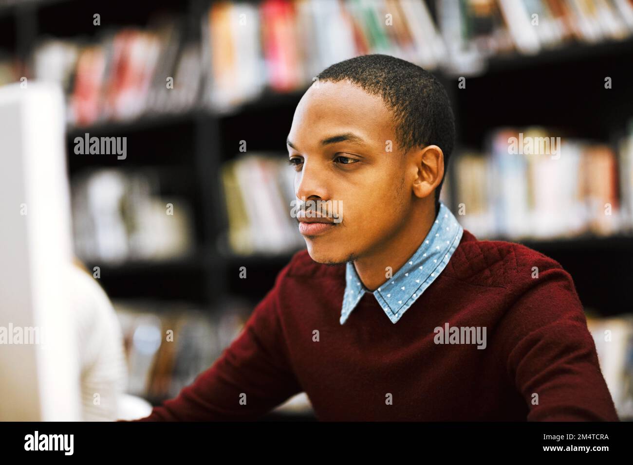The internet is full of information. a focused young man working on a ...