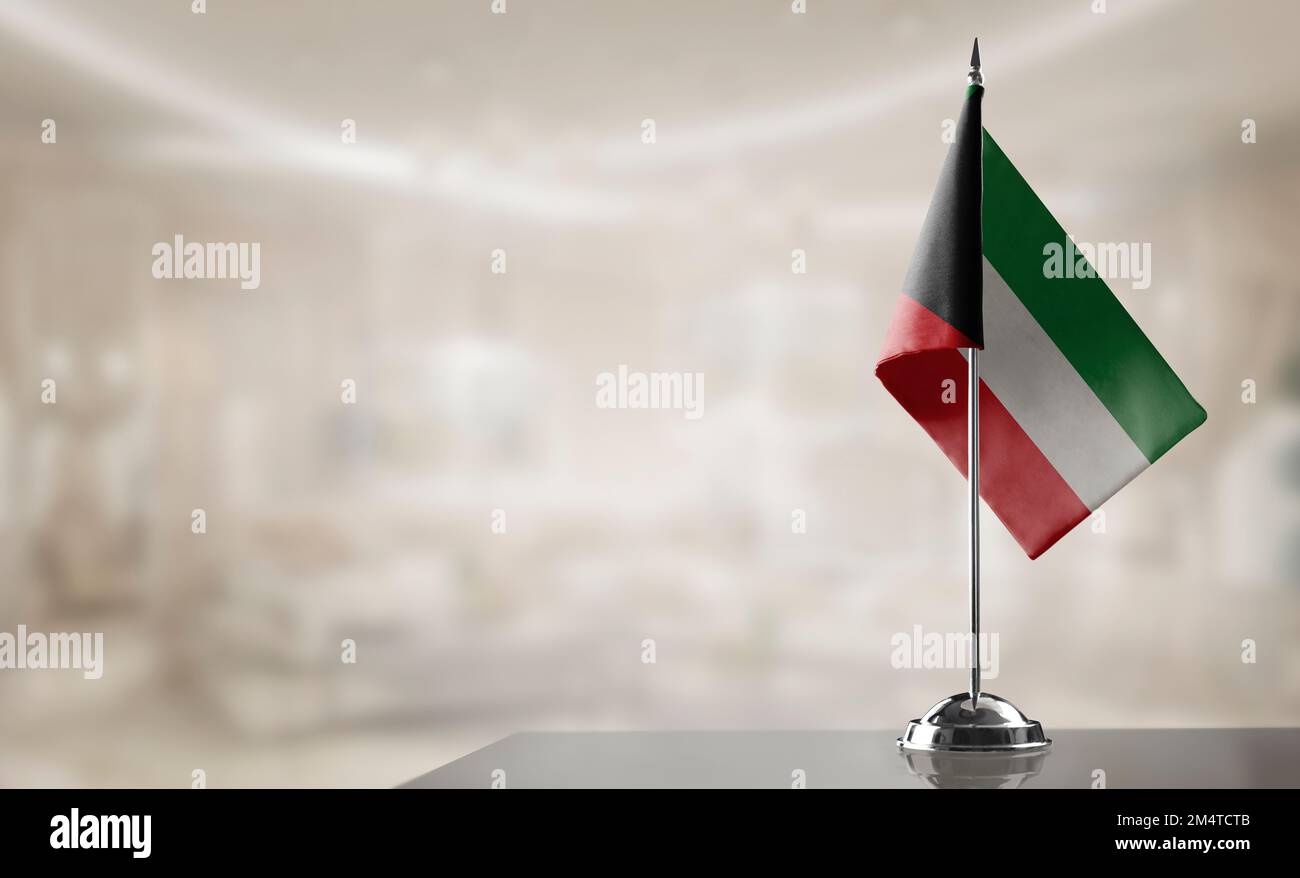 A small Kuwait flag on an abstract blurry background Stock Photo - Alamy