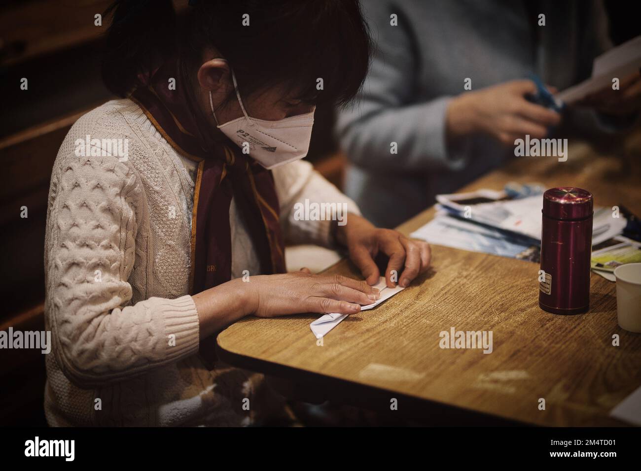A female with mask cutting a christian cross with paper Stock Photo - Alamy